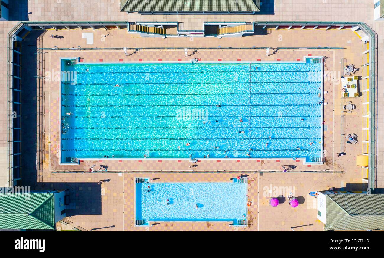 An aerial view of an outdoor Lido swimming pool in Summer sunshine ...