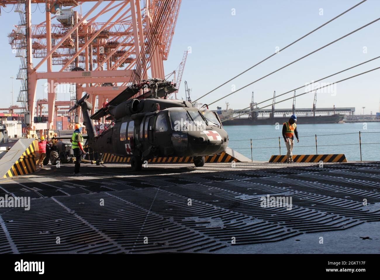 DynCorp aircraft maintenance workers load a UH60 Blackhawk onto the ...