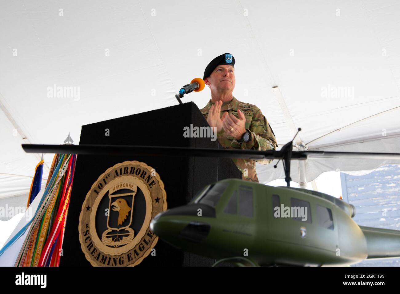 Maj. Gen. JP McGee encourages the audience to join him in a round of ...