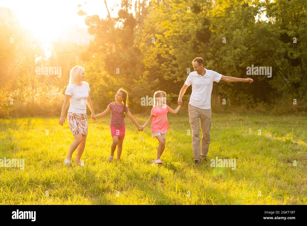 Happy family together bonding outdoors Stock Photo - Alamy