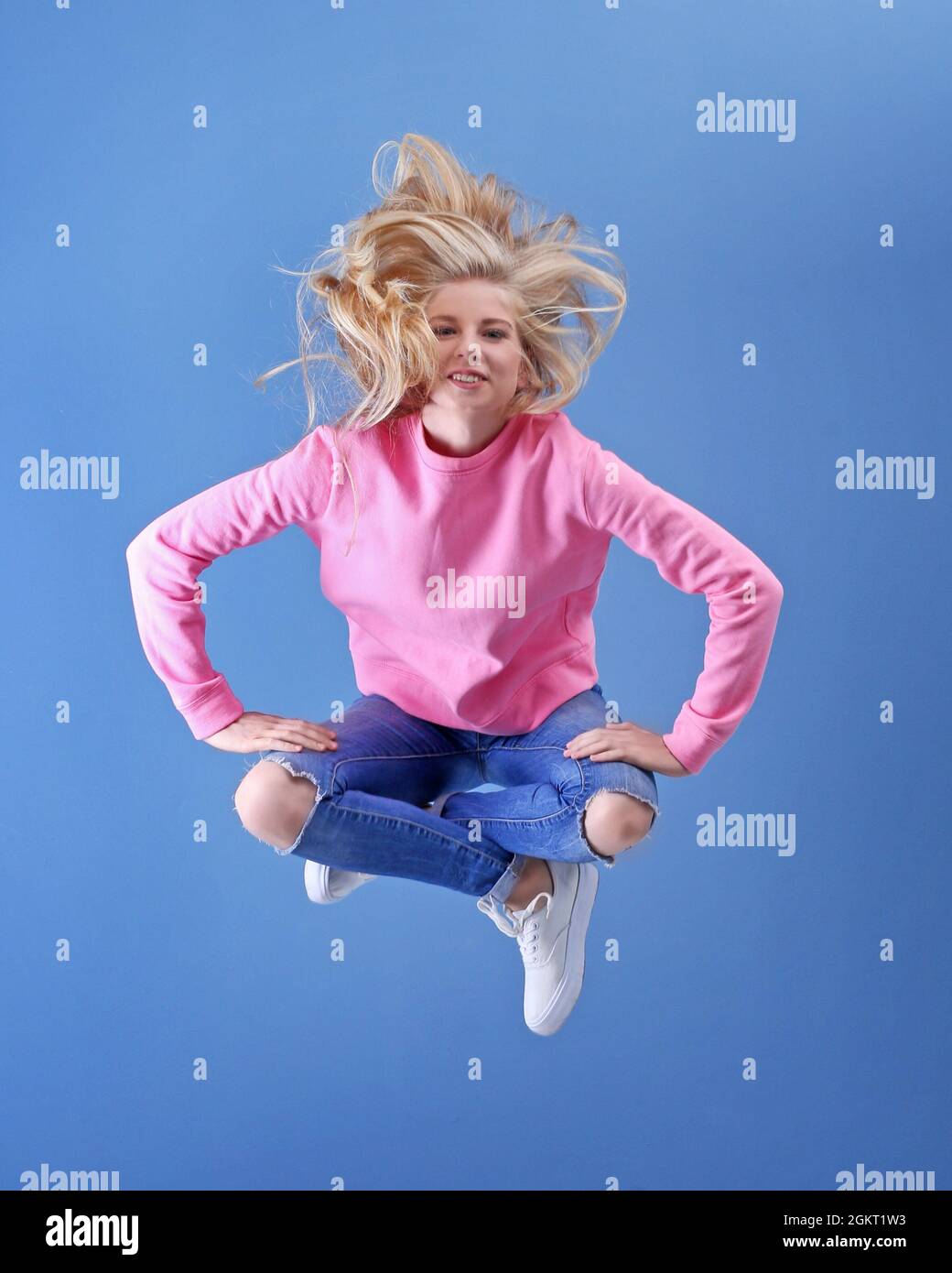 Jumping teenager girl on color background Stock Photo - Alamy