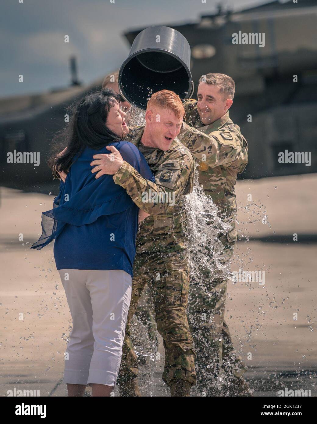 Cmd. Sgt. Maj. Zane Hansen douses Col. John Broam, commander of the ...