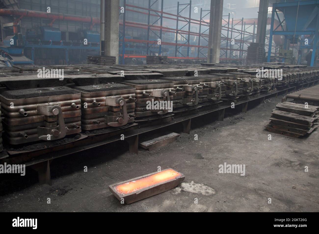 Steel factory. Liquid metal in molds Stock Photo - Alamy