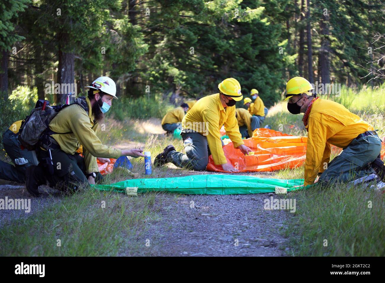 Sgt. 1st Class Peter Schuldt, 176th Engineer Company rolls up a ...