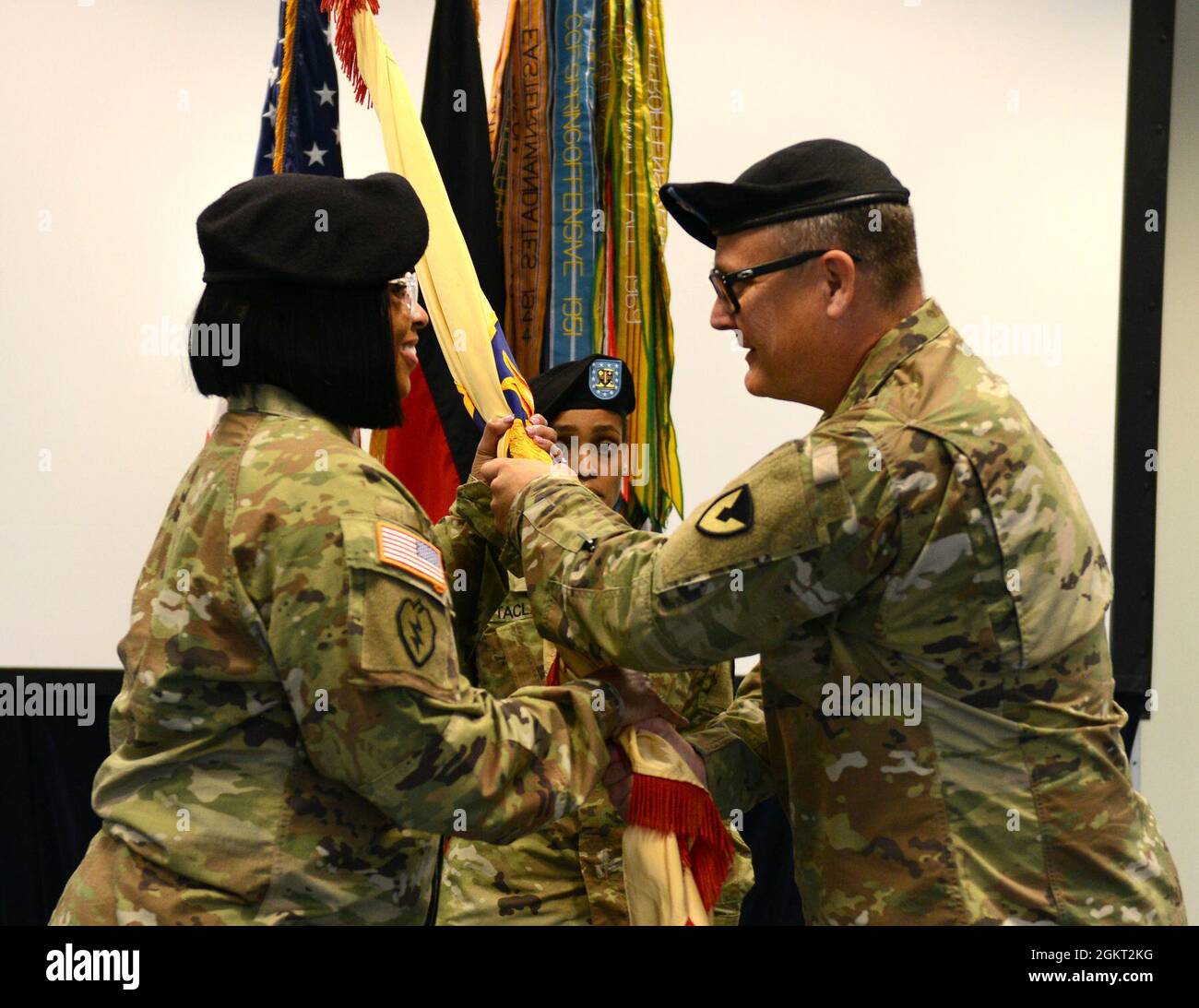 U.S. Army Col. Jarrett S. Moffitt, commander (right) passes the unit ...