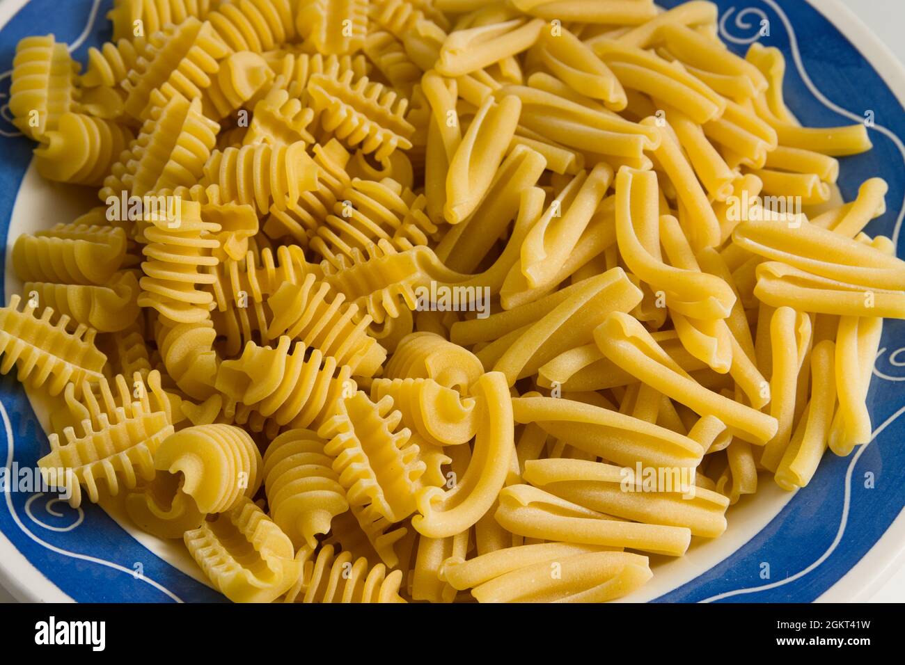 Closeup of a plate with various types of Italian pasta such as ...