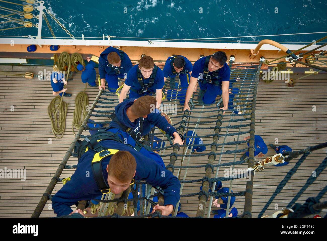 U.S. Coast Guard Academy cadets climb the main mast aboard USCGC Eagle ...