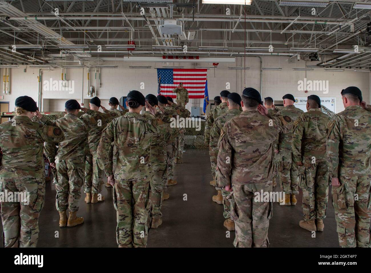 Maj. Michael Wetlesen, center, incoming 4th Security Forces Squadron commander, renders his ...