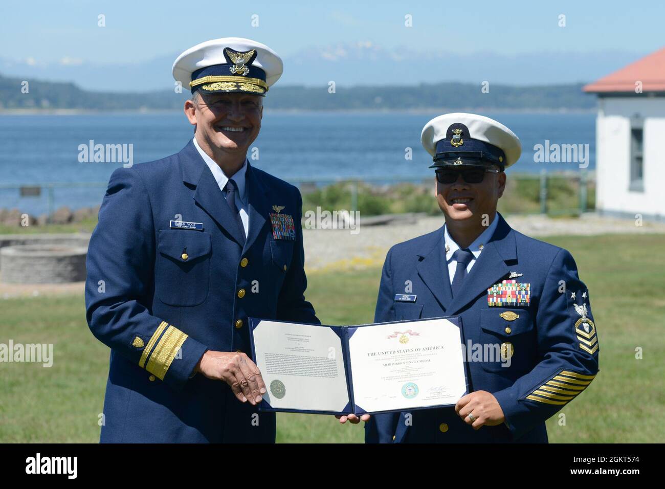 Rear Admiral Anthony "Jack" Vogt, commander, 13th District, presents ...