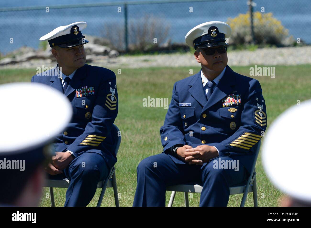 Master Chief Jason Wong and Master Chief Shane Carroll sit side-by-side ...
