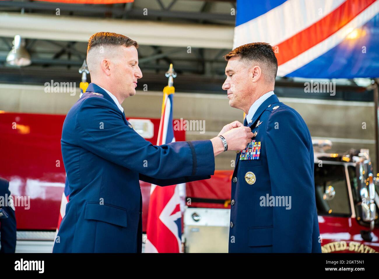 U.S. Air Force Col. Richard Martin, left, 423rd Air Base Group commander, pins a Meritorious ...