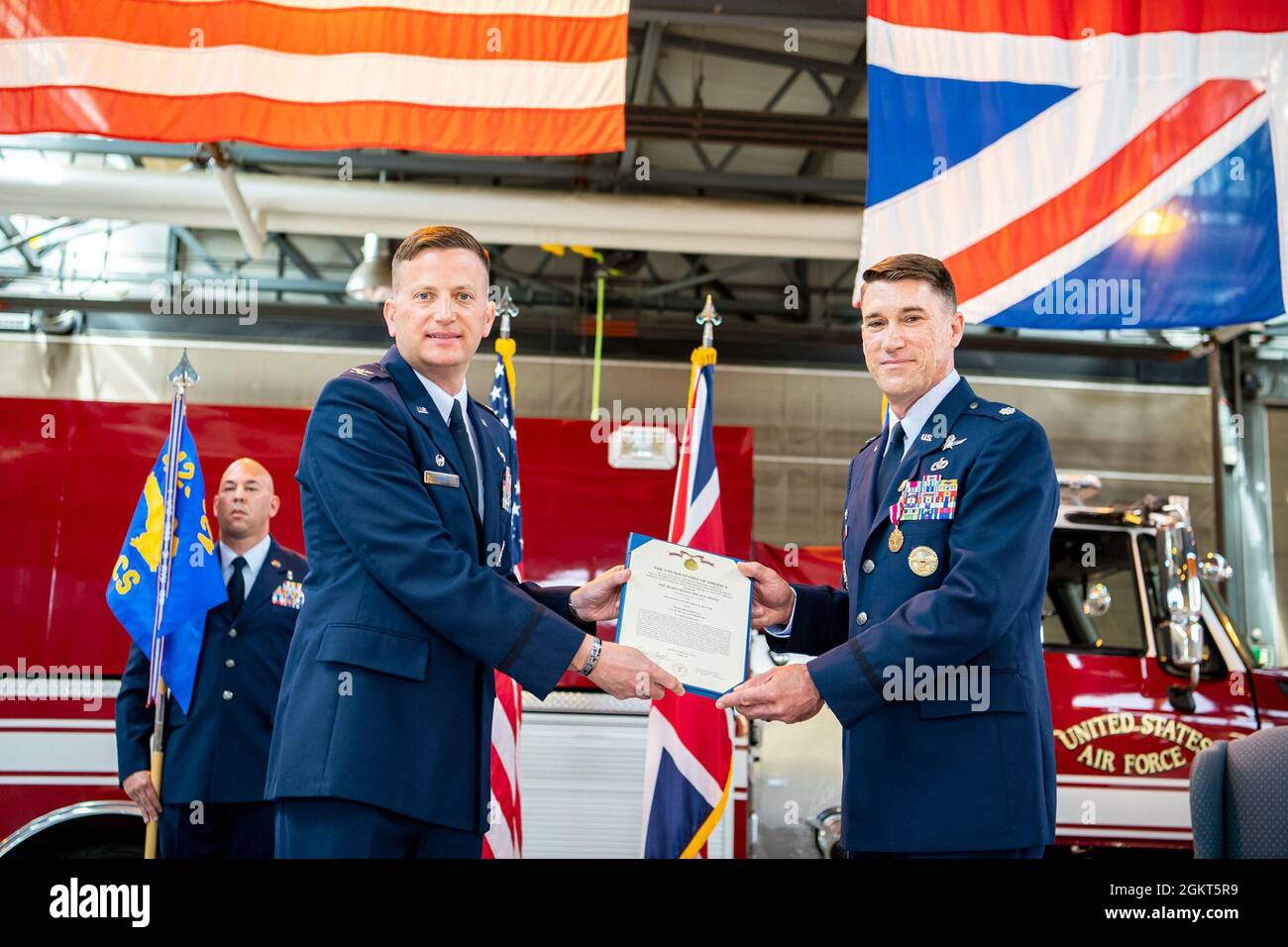 U.S. Air Force Col. Richard Martin, left, 423rd Air Base Group commander, presents a Meritorious ...