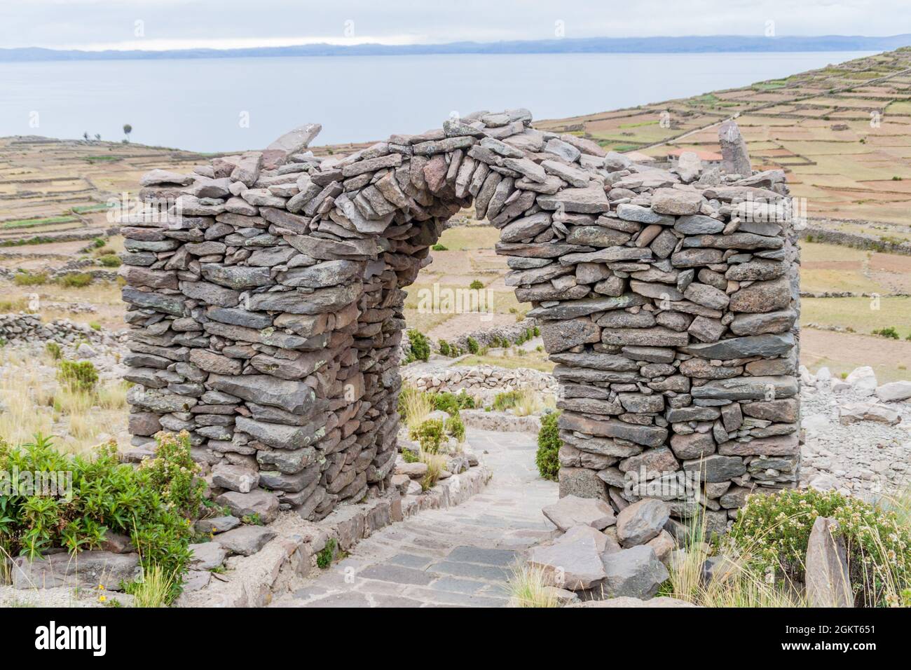 Stone arch on Pachatata hill on Amantani island in Titicaca lake, Peru ...