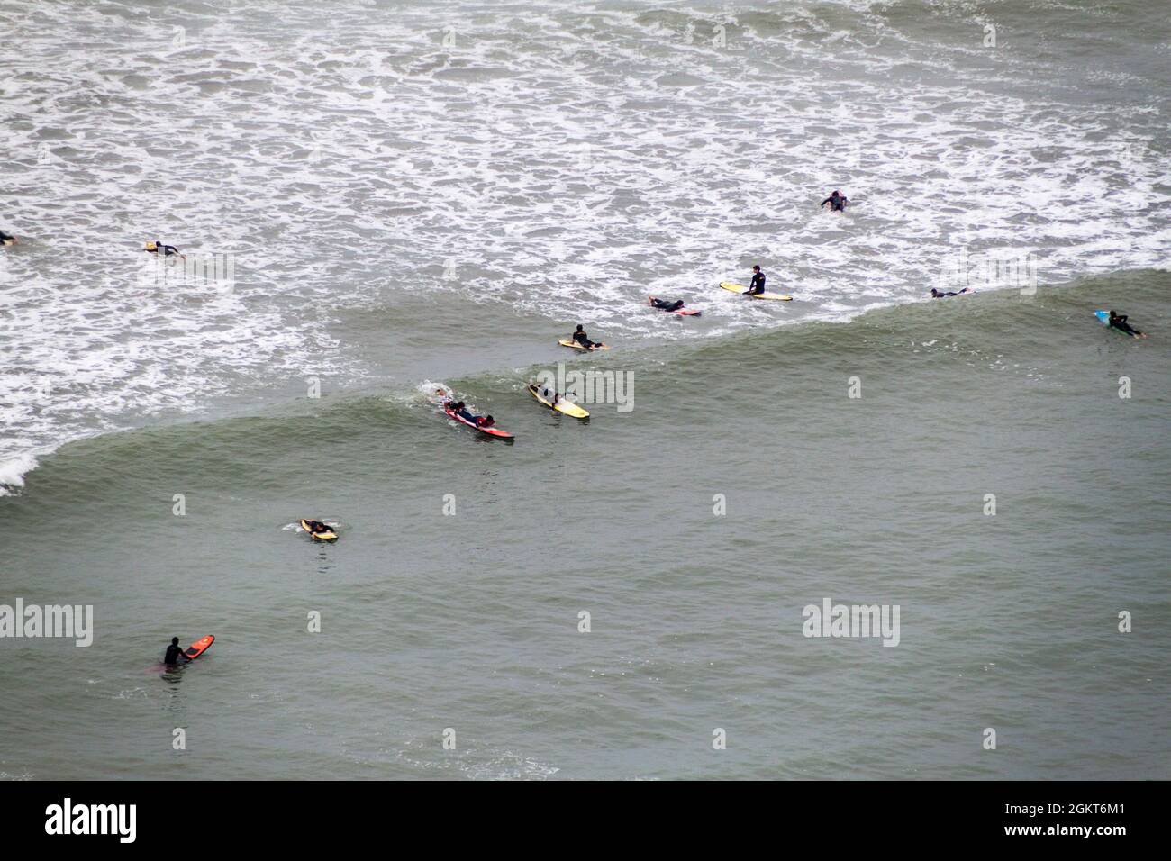 LIMA, PERU - JUNE 4, 2015: People surf on waves of an ocean. Miraflores ...
