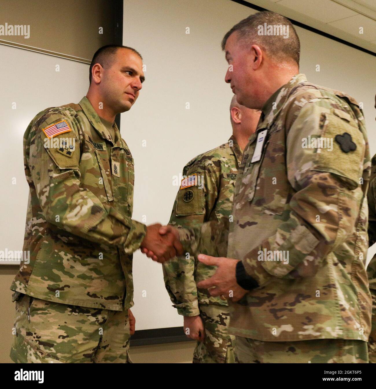 Sergeant Maj. Ronald Hoffmann, left, 88th Readiness Division, shakes ...