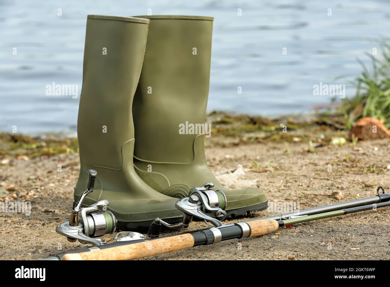 Fishing rod and gumboots on beach Stock Photo - Alamy