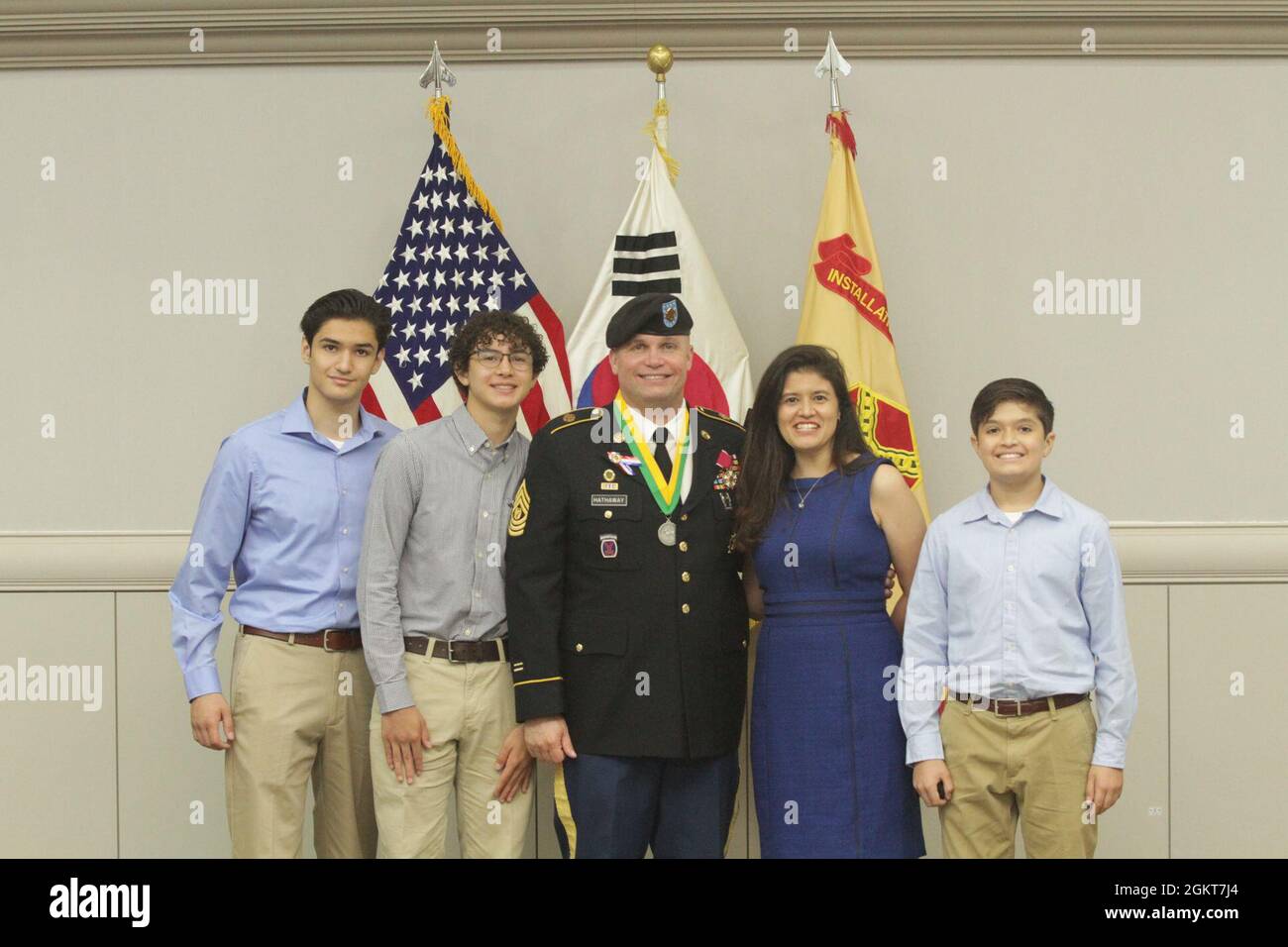 Command Sgt. Major Jason Hathaway stands with his wife Laura, and sons ...
