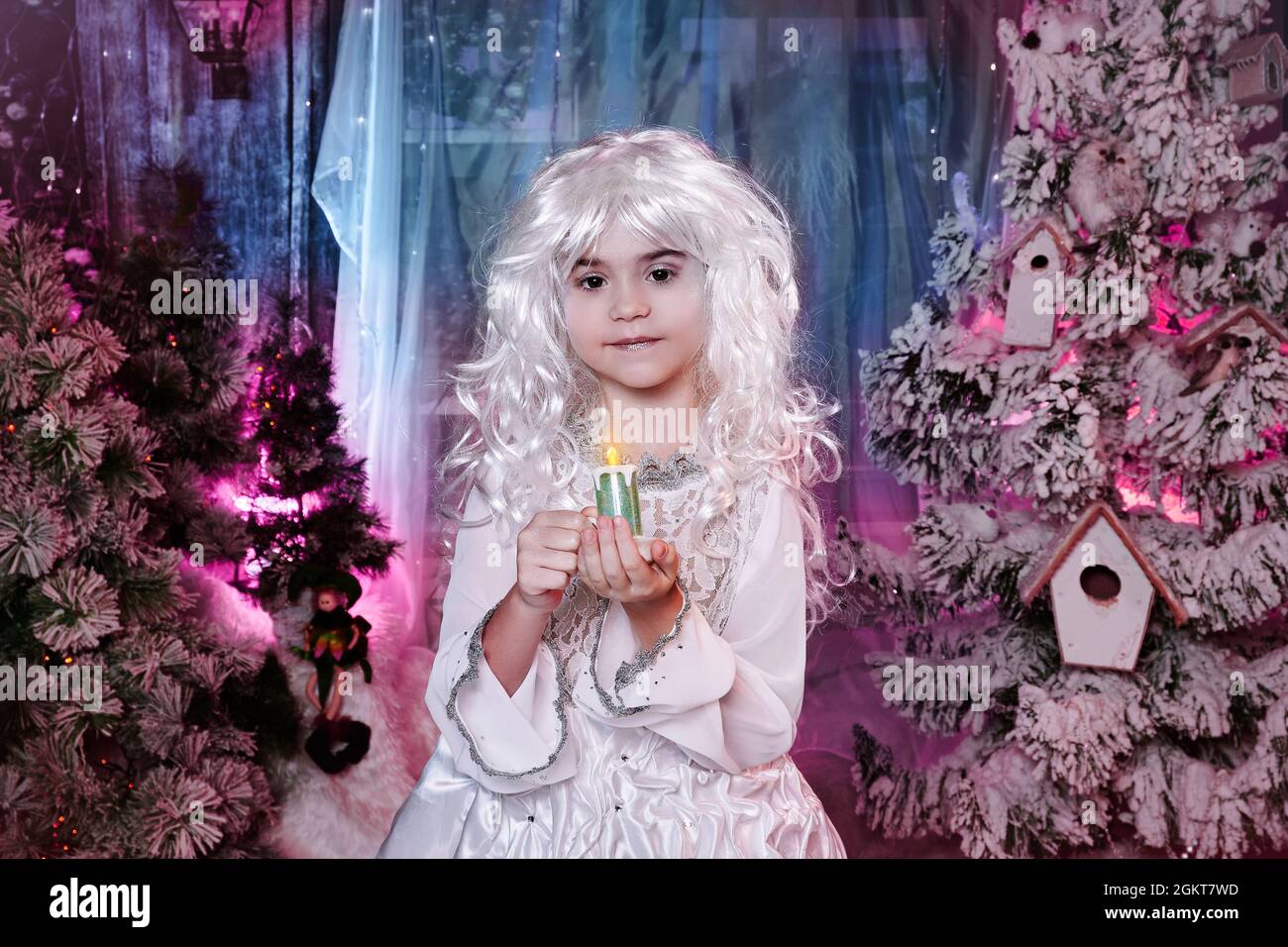 snow fairy in the forest holds a lamp with fire in her hands. fabulous ...