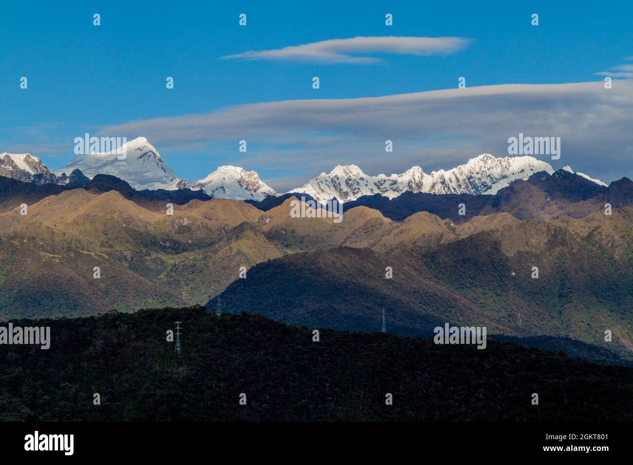 Sun is rising over snow capped mountains near Machu Picchu ruins, Peru ...