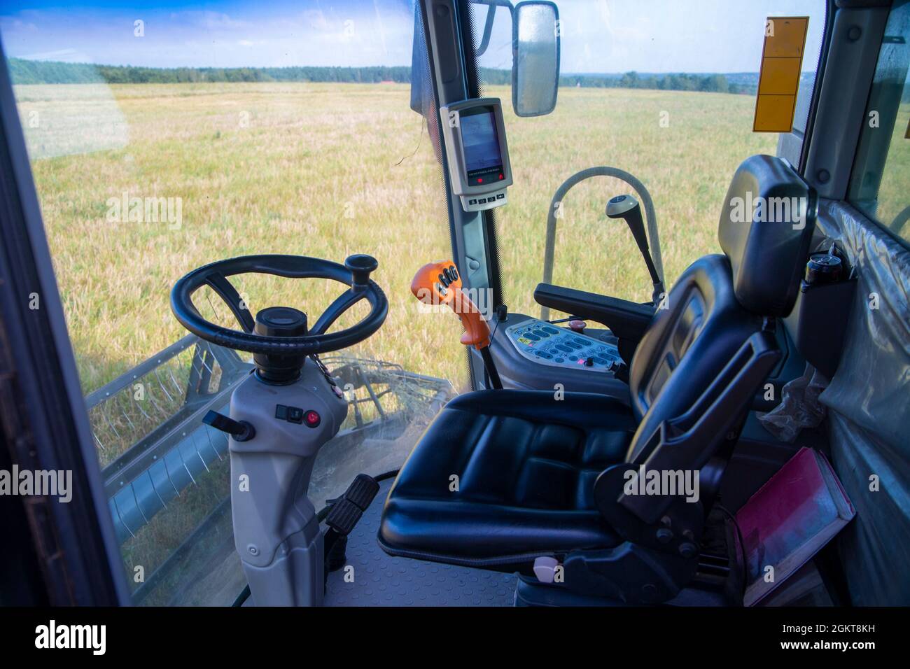 View of the field of corn from the cab of a combine harvester on a ...