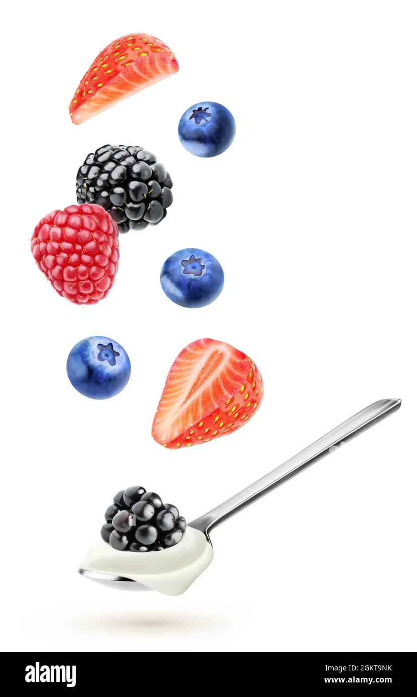 Spoon with natural yogurt and flying berries (strawberry, blueberry ...