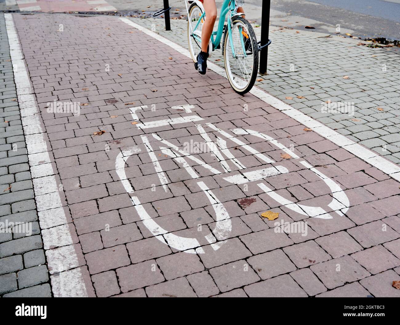 Close up of woman riding on blue modern bicycle in centre city on ...