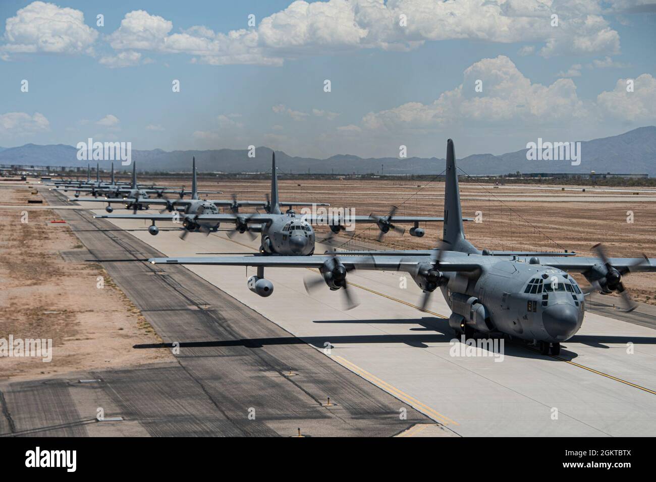 Seven U.S. Air Force EC-130H Compass Calls taxi down the flight line ...