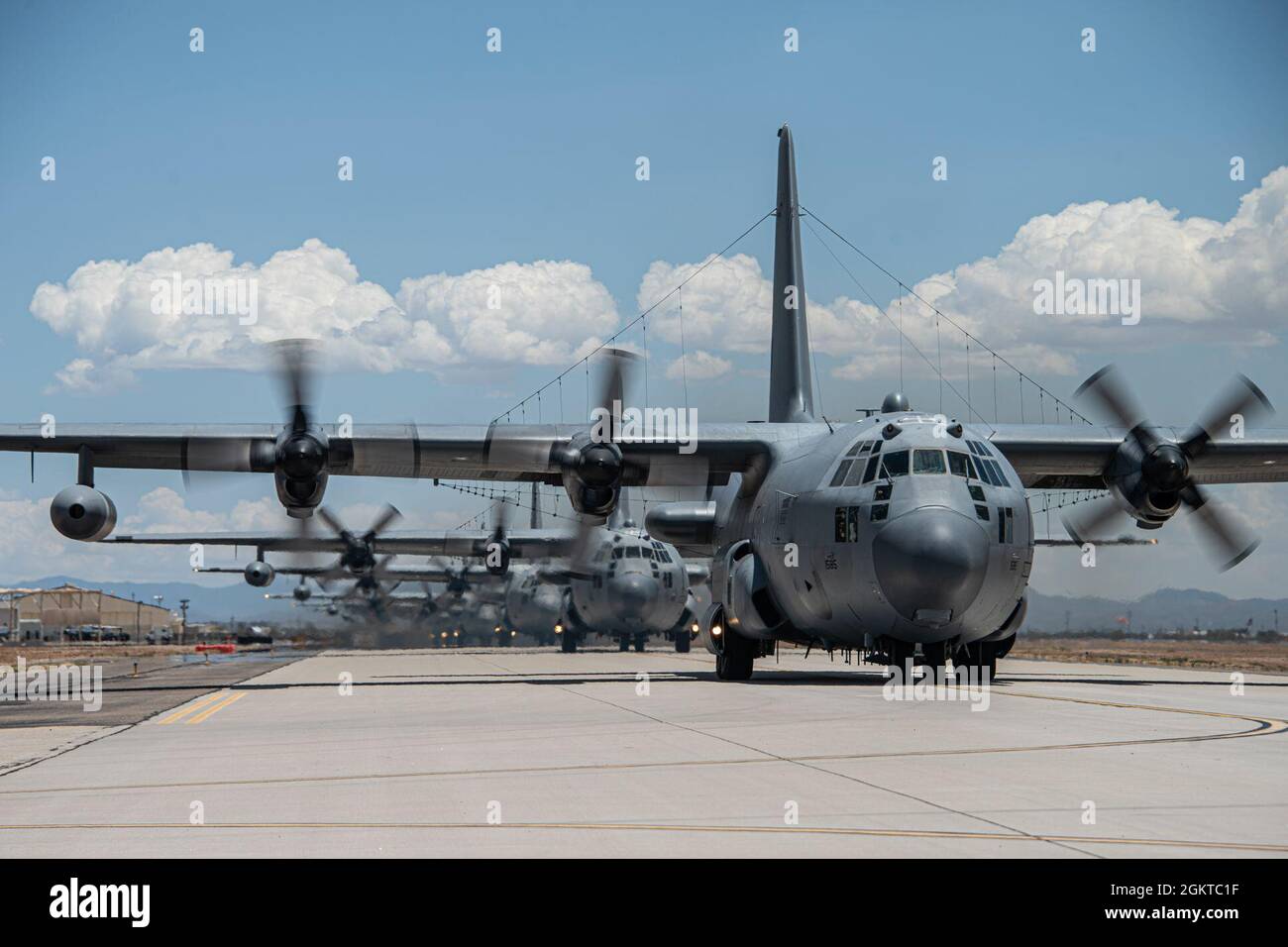 Seven U.S. Air Force EC-130H Compass Calls taxi down the flight line ...