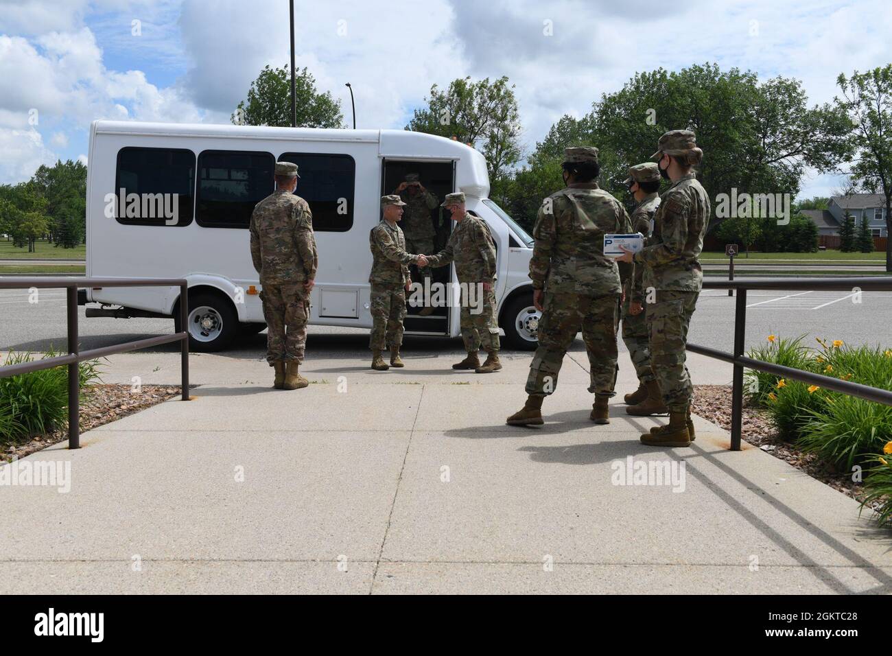 Col. Jason Musser, 319th Medical Group commander, shakes hands with Lt ...