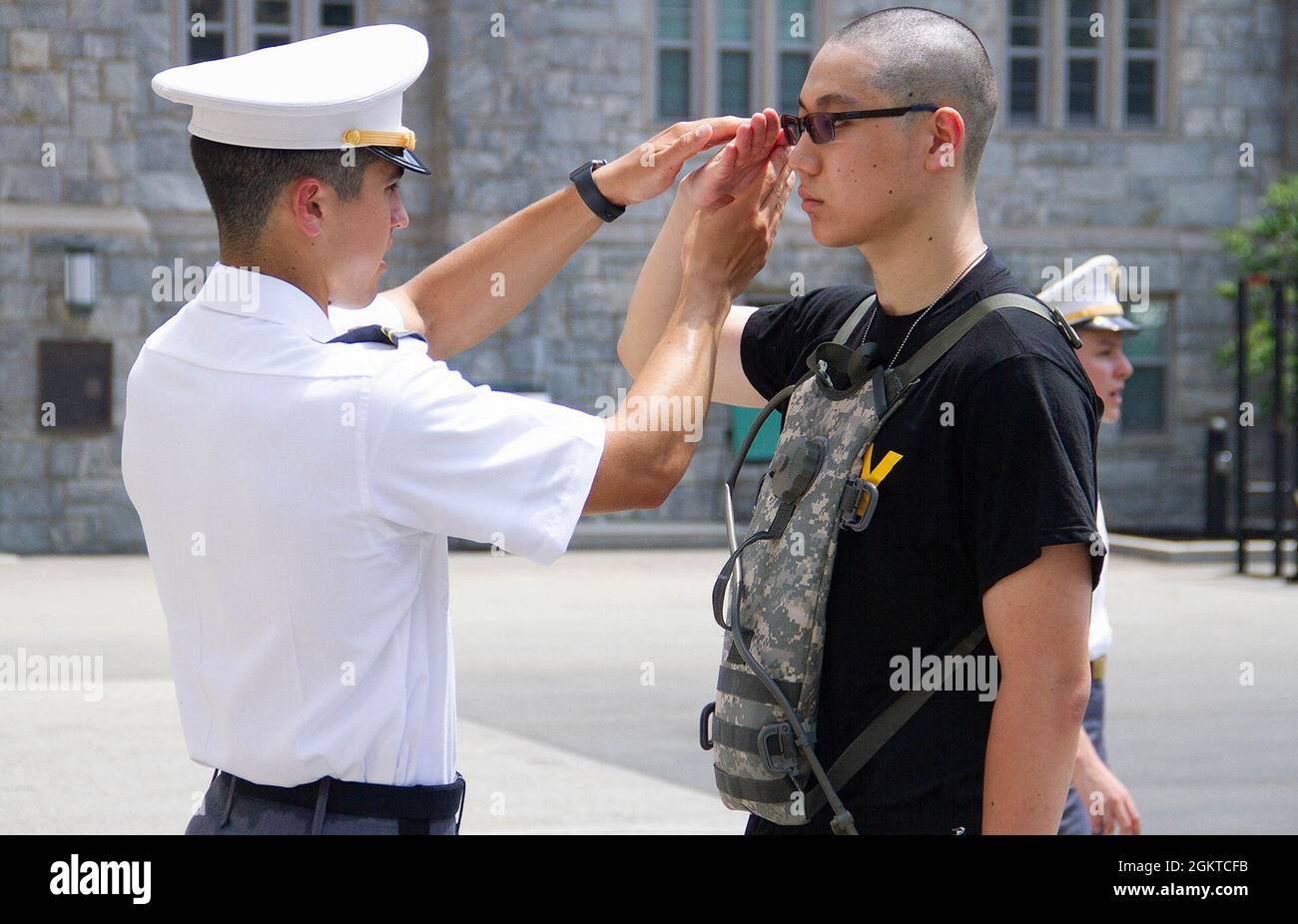 A U.S. Military Academy at West Point junior teaches a new cadet how to ...