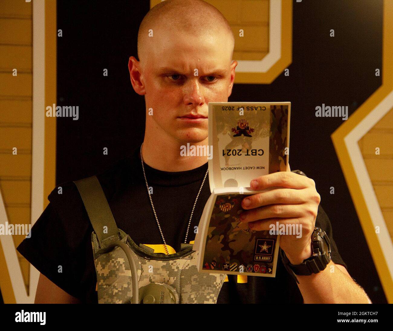 A new cadet reads the New Cadet Handbook during Reception Day at West ...
