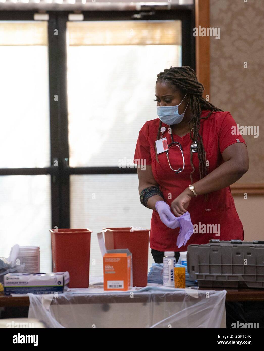 An American Red Cross volunteer prepares to take blood donations during ...