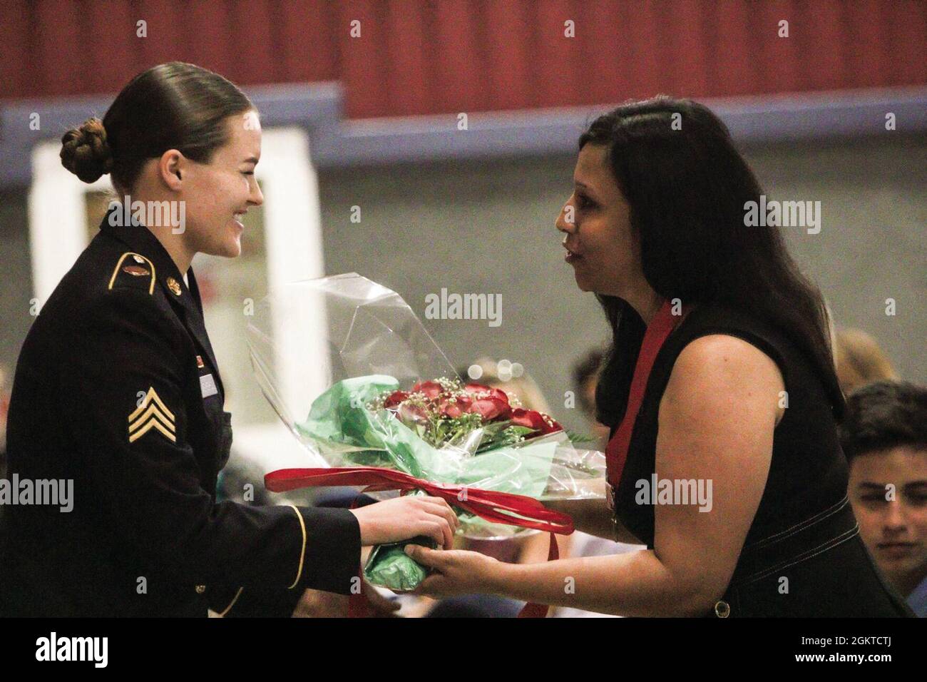 Karen Bell receives a bouquet of flowers as her husband, Col. Jeremy D ...