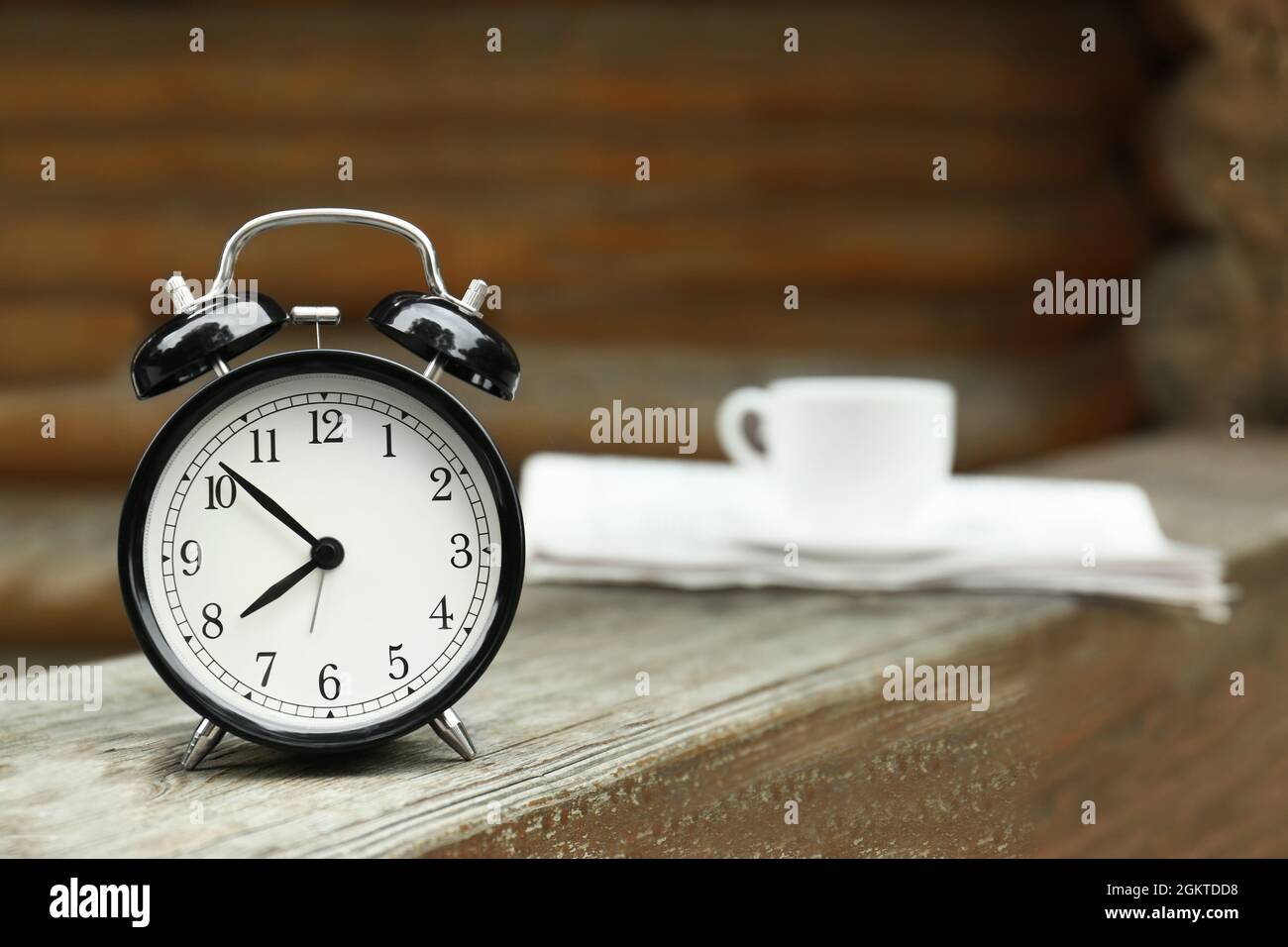 Alarm clock on wooden bench outdoors. Morning routine concept Stock ...