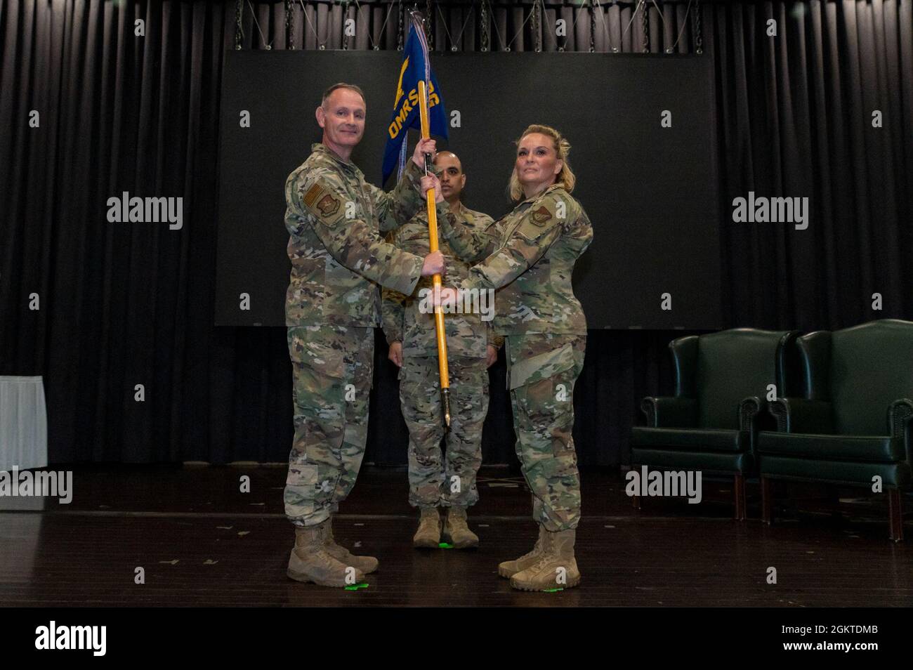 Col. Michael Fea, 51st Medical Group commander, left, passes the guidon ...