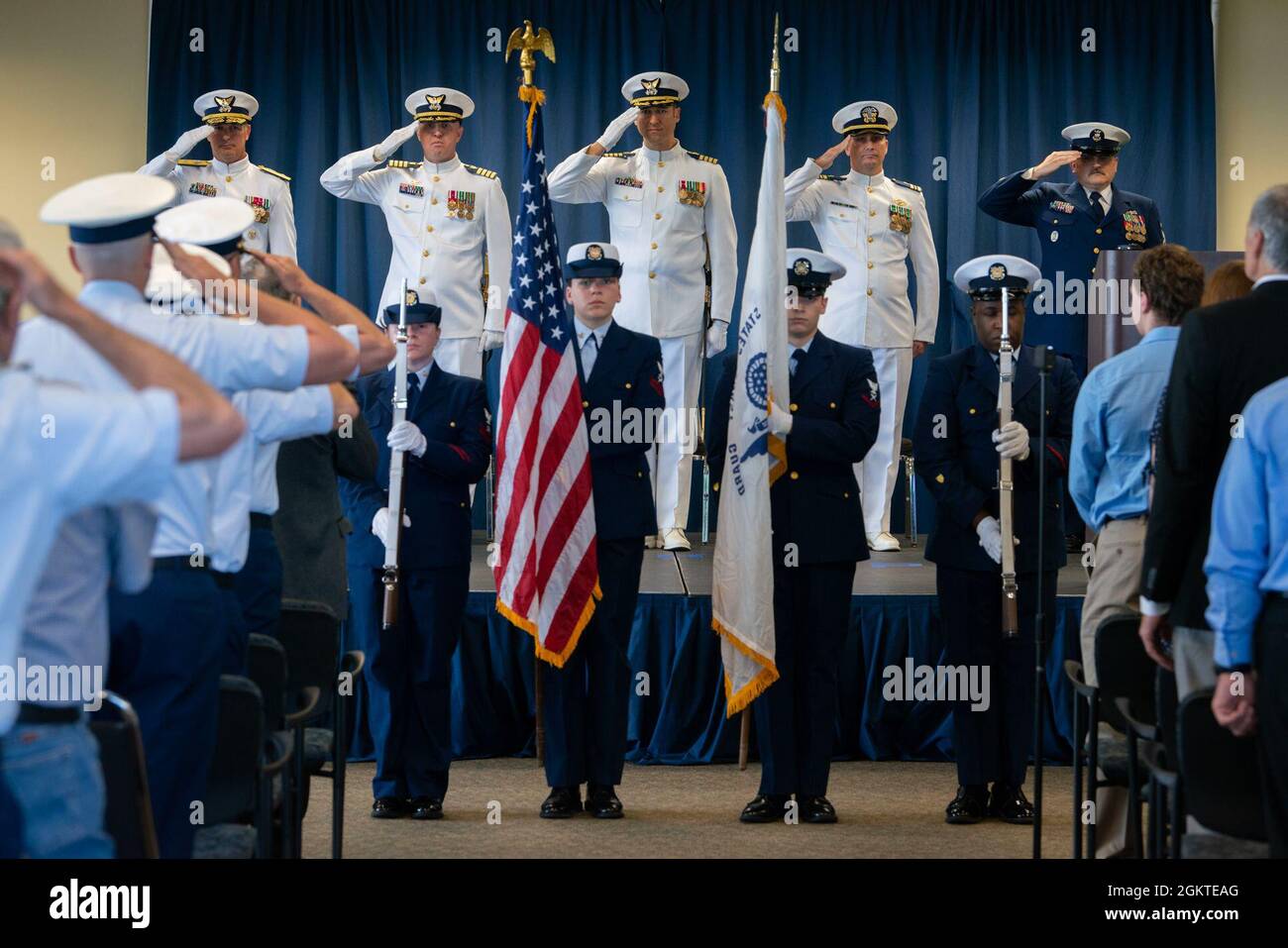 U.S. Coast Guard personnel render honors to the flag during a change-of ...