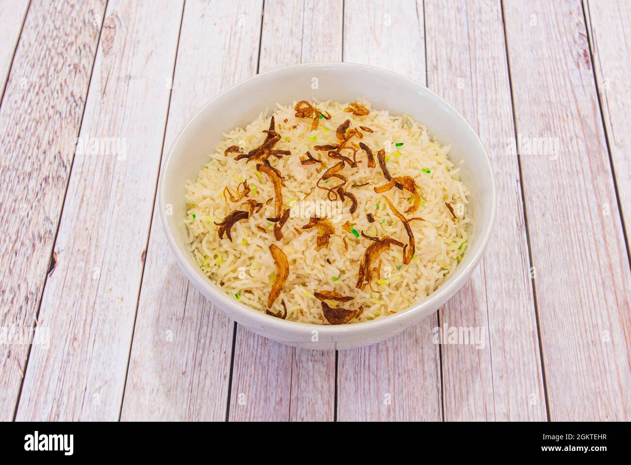bowl of pilau basmati rice with brown onion cooked in Indian restaurant ...