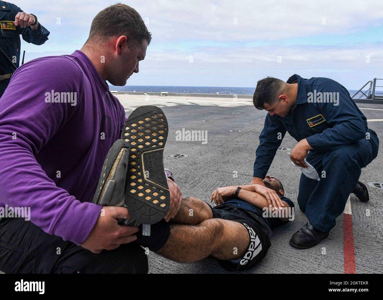 ATLANTIC OCEAN (JUNE 29, 2021) Fireman Jonathan Torres, right, applies ...