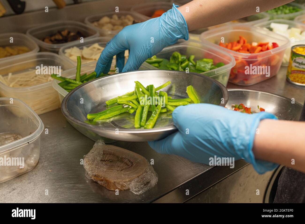 Hands of a Chinese chef collecting ingredients to prepare an Asian ...