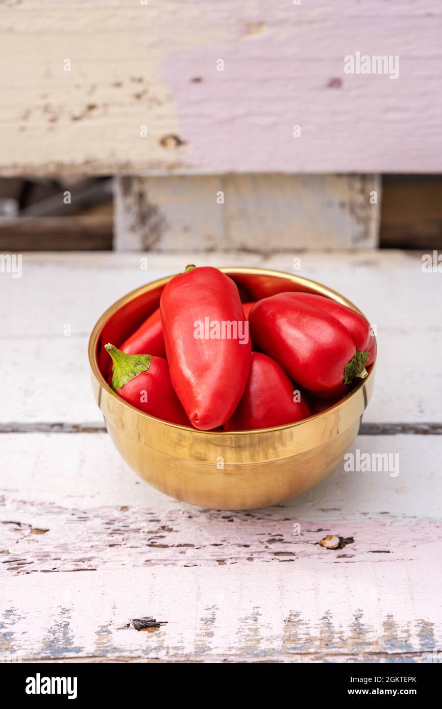Golden bowl full of peppers on pallet painted with pale chalk paint ...