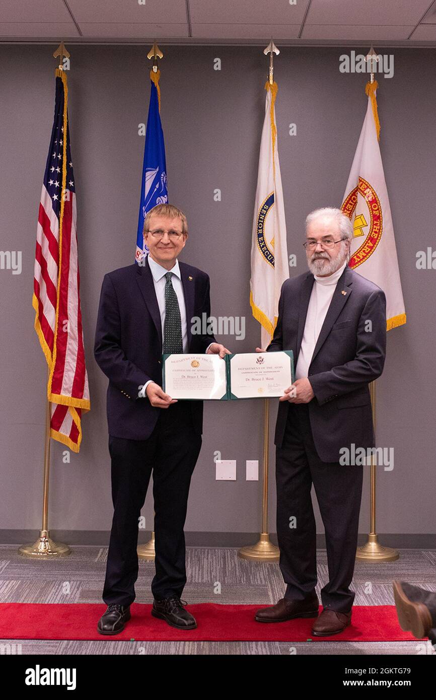 Dr. Patrick Baker, DEVCOM ARL director (left) presents Dr. Bruce J ...