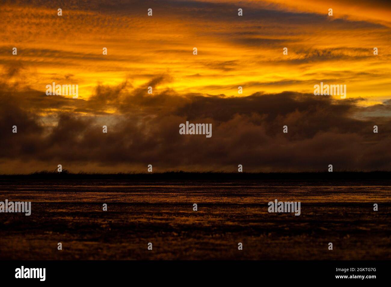 An Ie Shima coral runway remains empty under the sunset during a ...