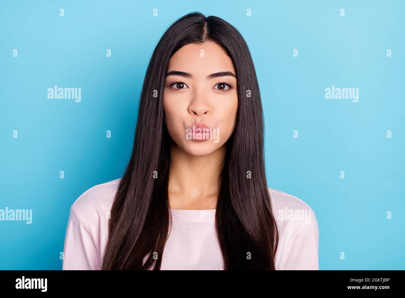 Photo of charming satisfied black hair young lady kiss lips look camera ...