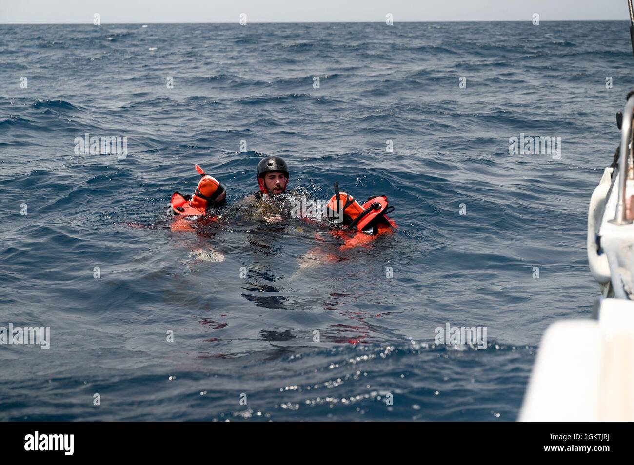 French Air Force rescue divers prepare to hoist a simulated patient during a joint water rescue ...