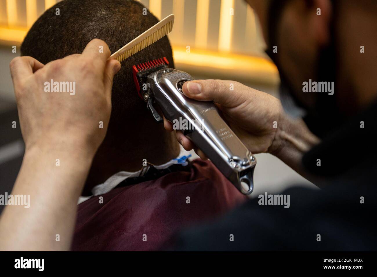 Maj. Gen. Randall Reed, Third Air Force commander, receives a haircut ...