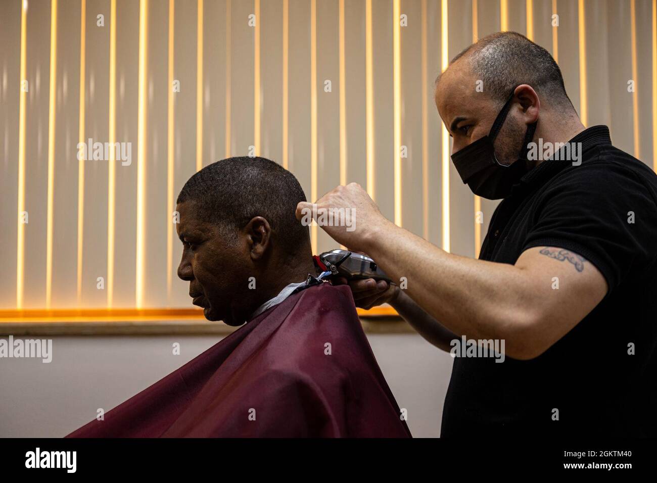 Maj. Gen. Randall Reed, Third Air Force commander, receives a haircut ...