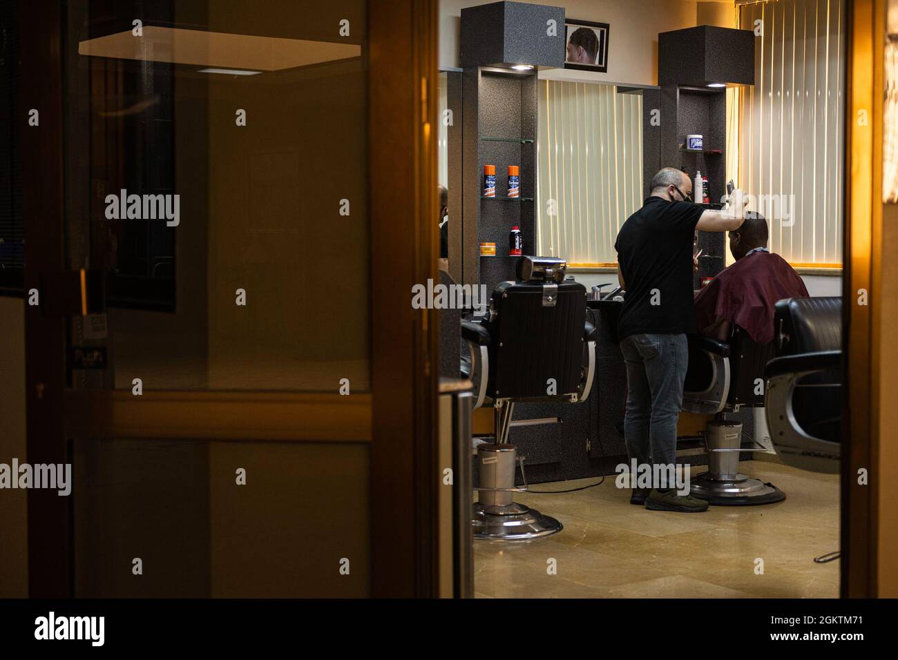 Maj. Gen. Randall Reed, Third Air Force commander, receives a haircut ...