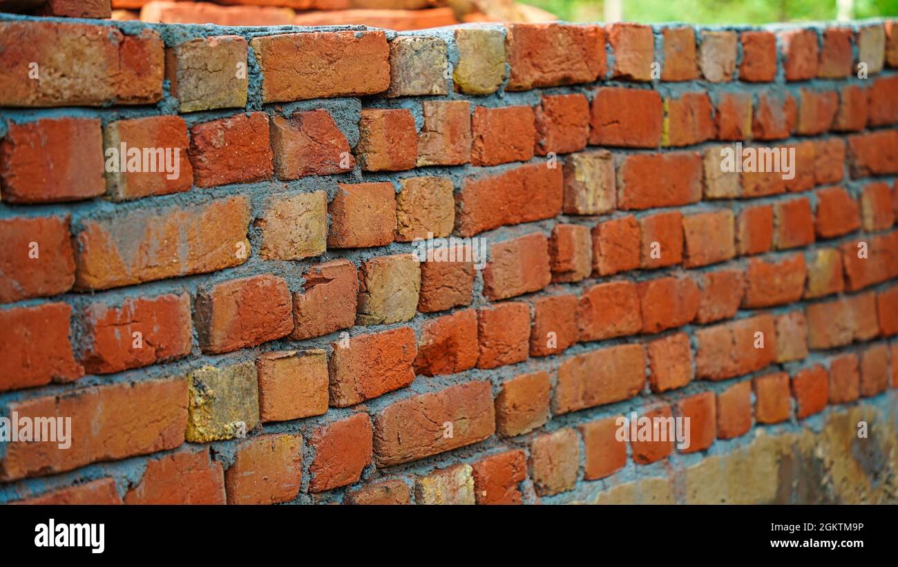 Incomplete structure of a new house being built in India. New wall made ...