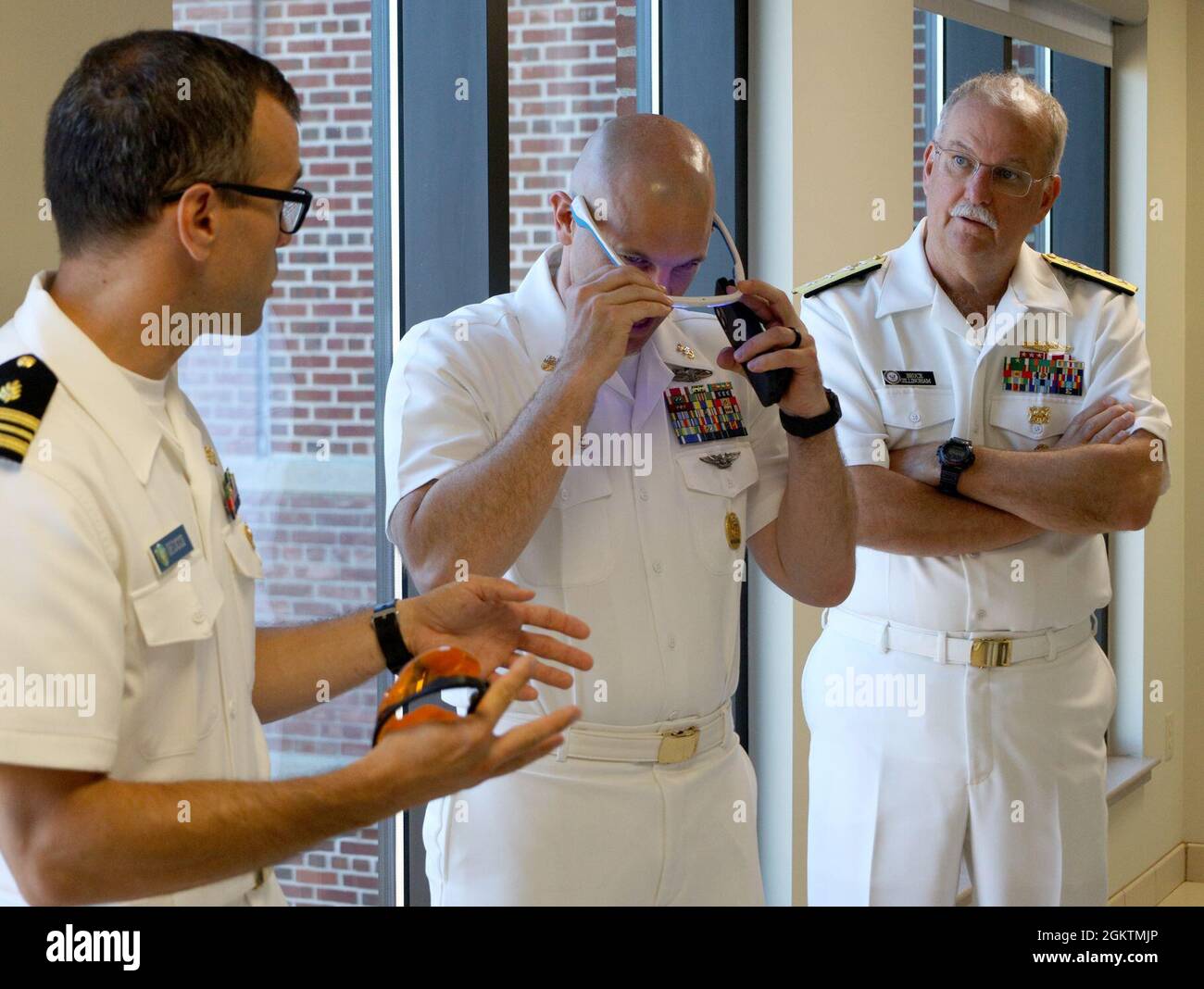 With the U.S. Navy Surgeon General Rear Adm. Bruce Gillingham looking ...