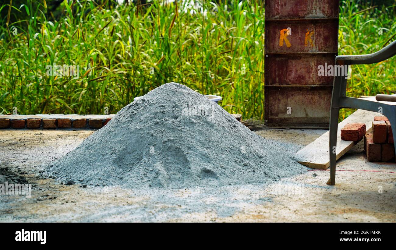 Small pile of cement and concrete at construction site in a village ...